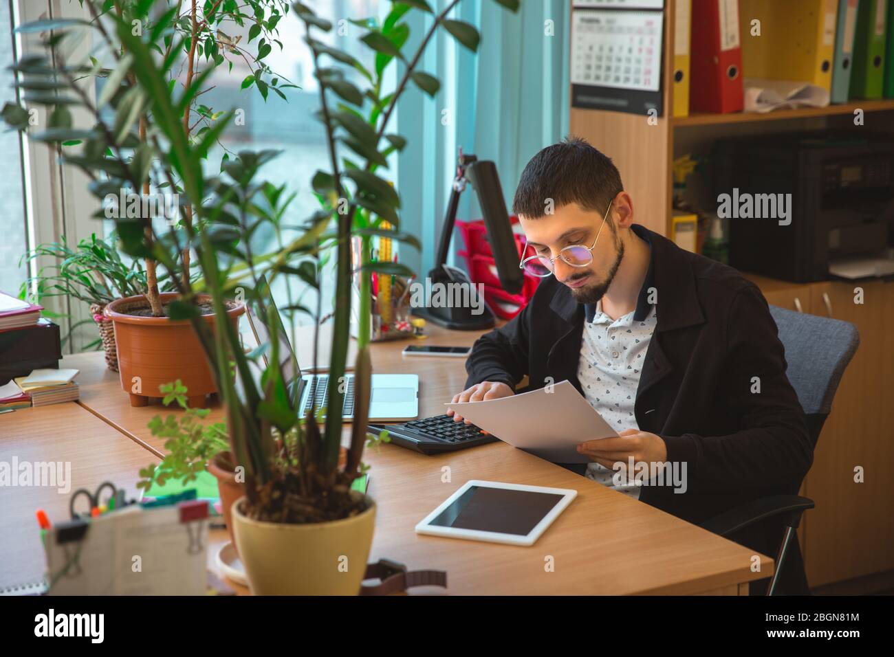 Using gadgets. Caucasian entrepreneur, businessman, manager working ...