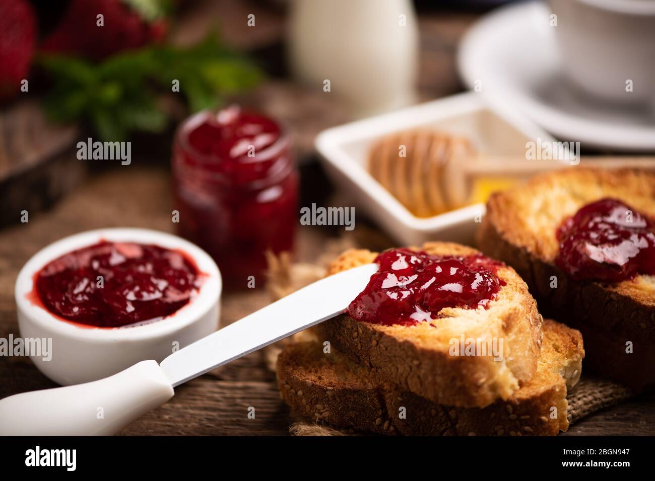 Fresh strawberry jam with bread for breakfast close up Stock Photo - Alamy