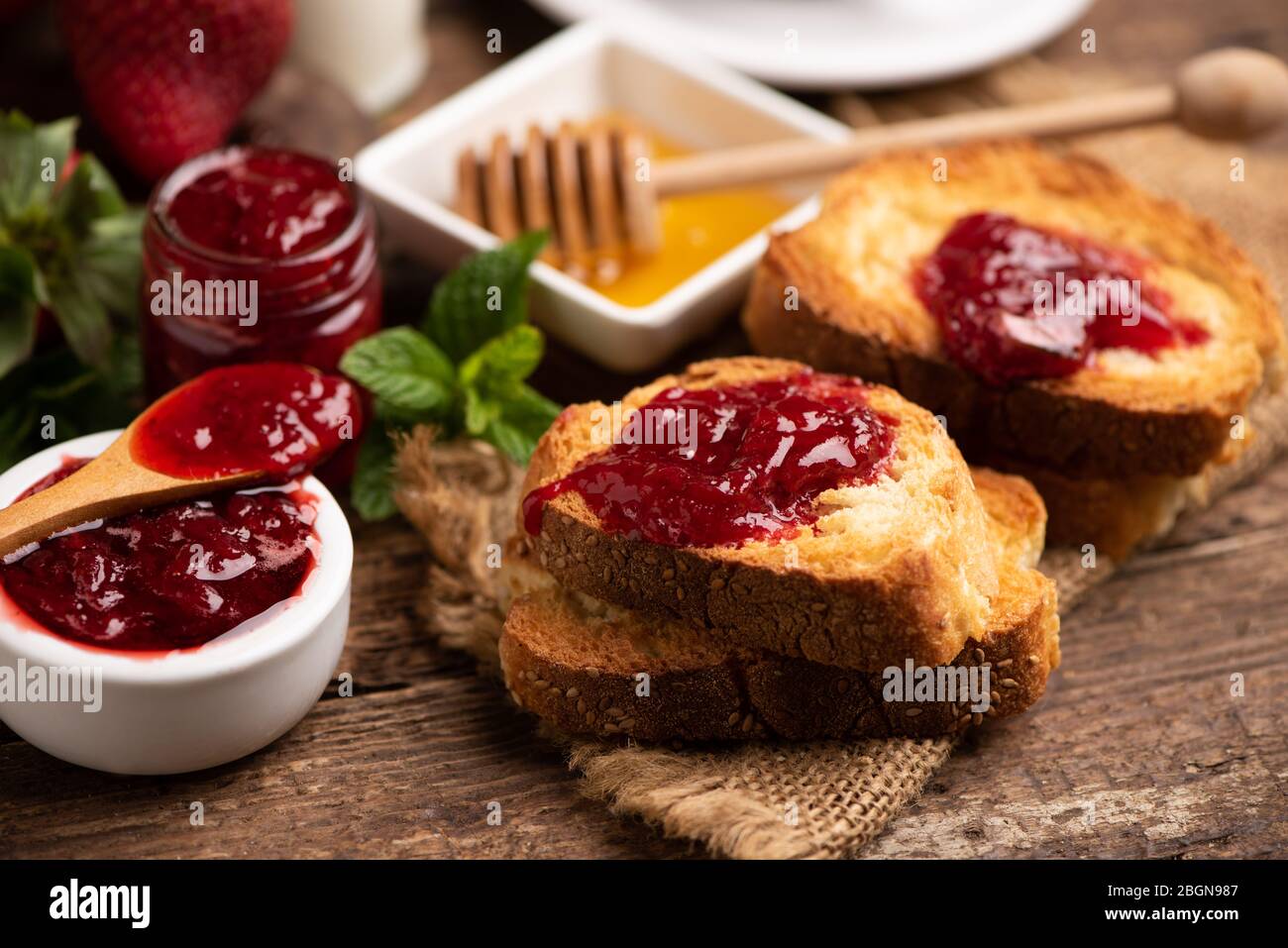 Fresh strawberry jam with bread for breakfast close up Stock Photo - Alamy