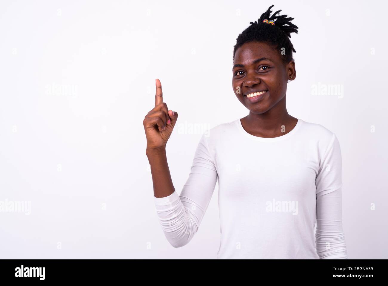 Portrait of happy young beautiful African woman pointing up Stock Photo ...