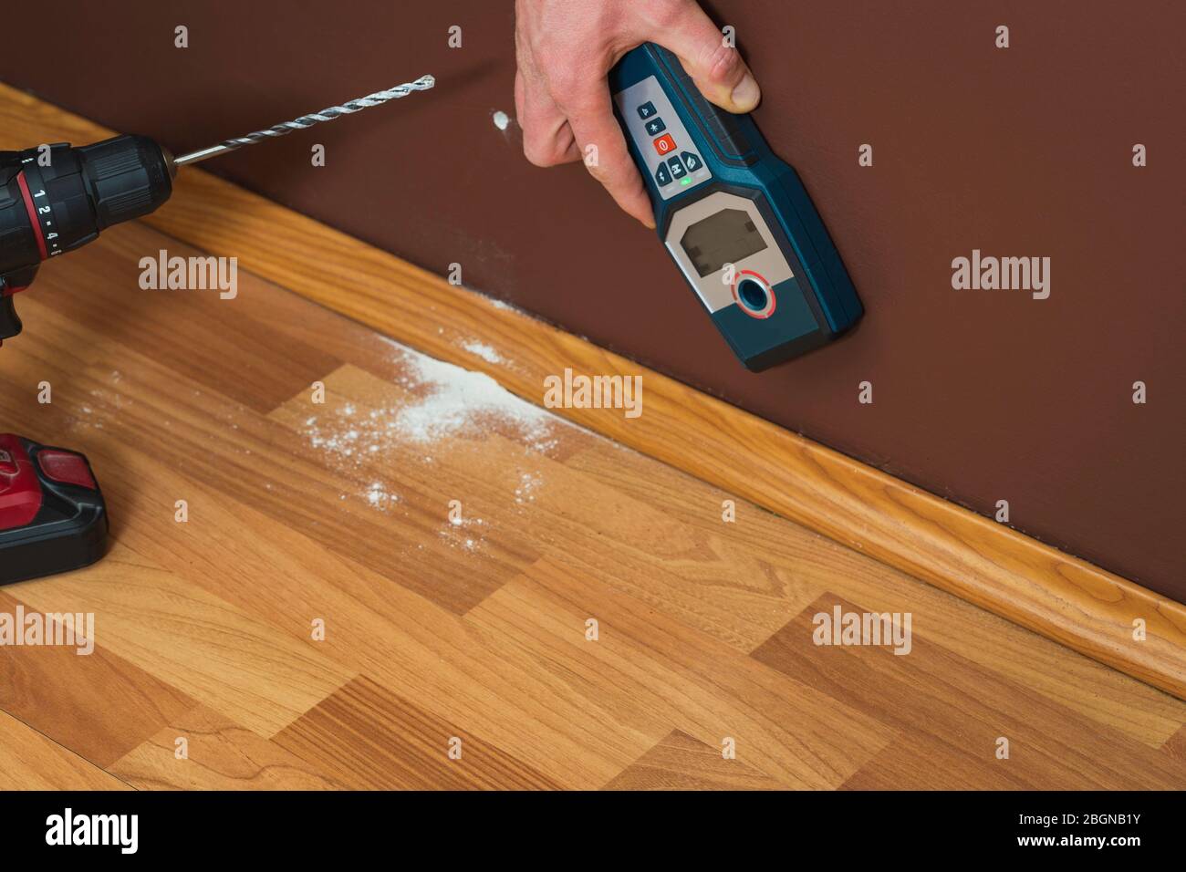 Man hand is scanning wall by cable detector to find a cable before ...