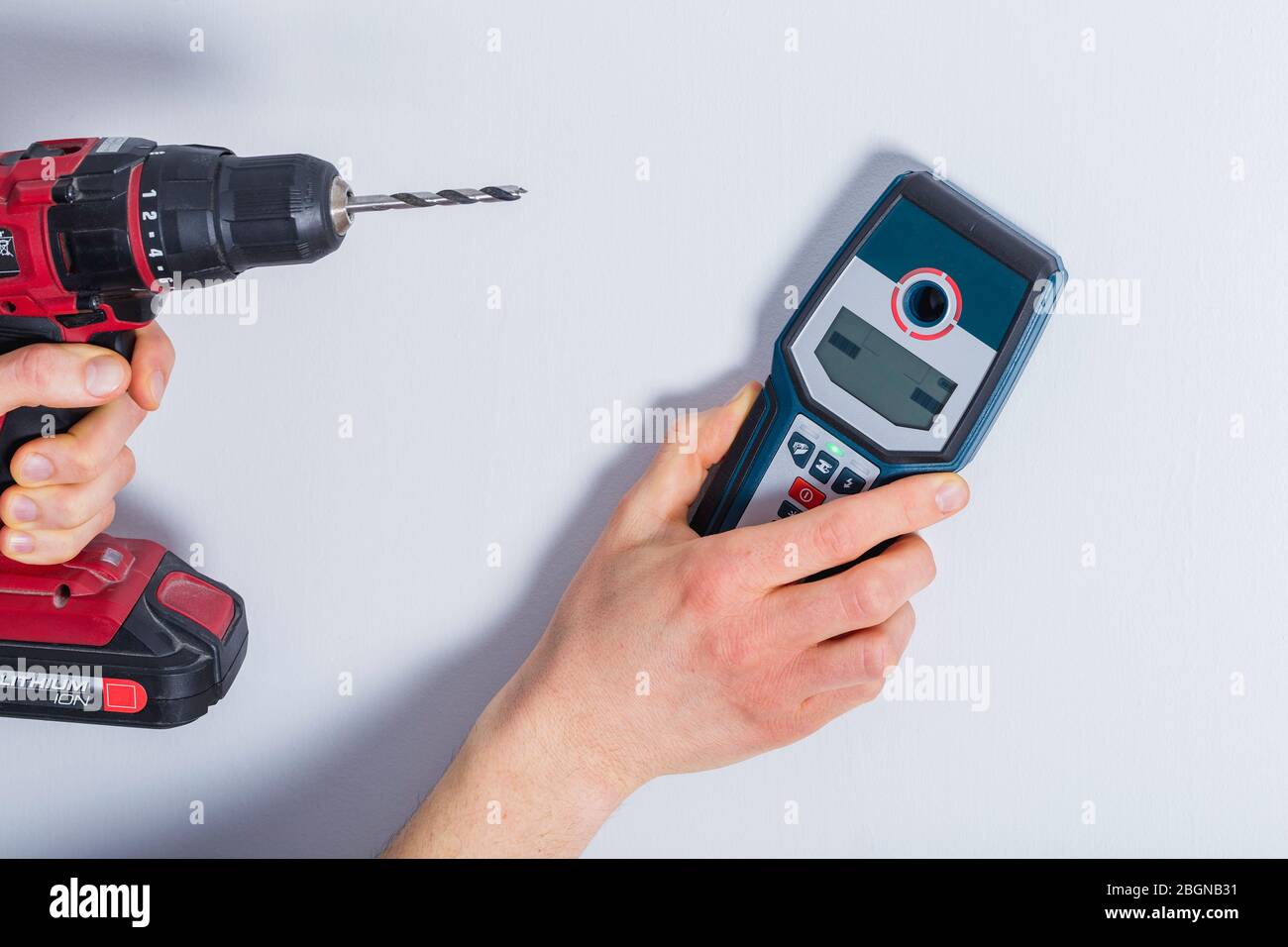 Man hand is scanning wall by cable detector to find a cable before ...