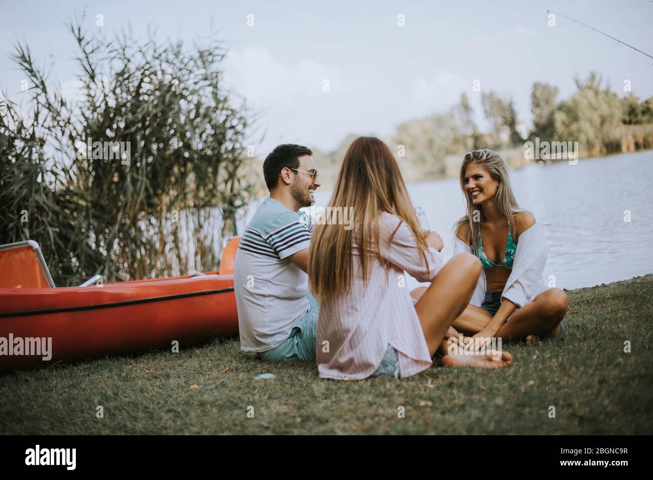 Group of happy young friends enjoying the nature on the lakeside Stock ...
