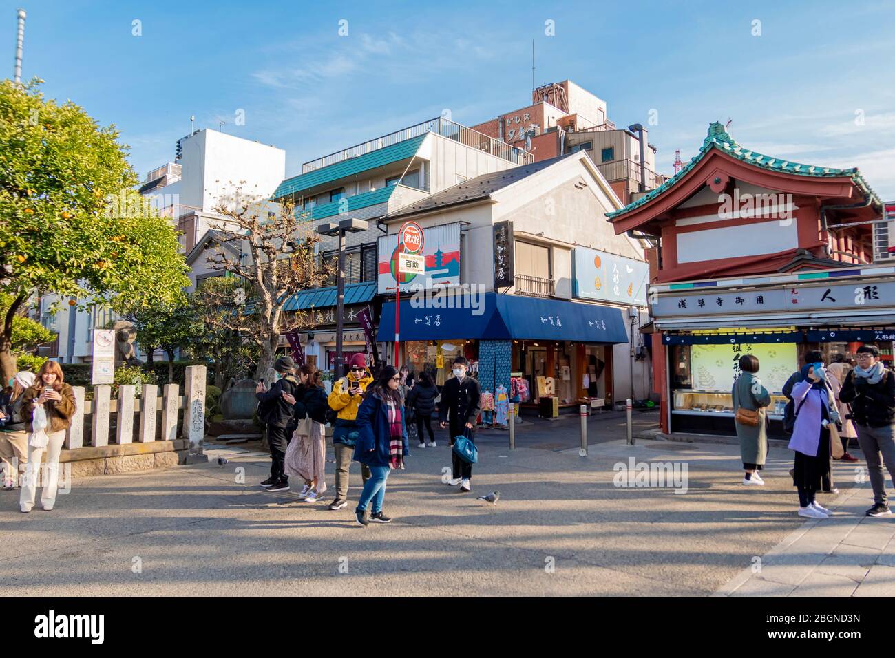 People wearing mask while walking in Asakusa temple park beside ...