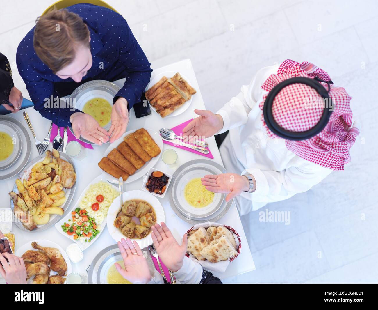 Eid Mubarak Muslim people praying before iftar dinner. Eating ...