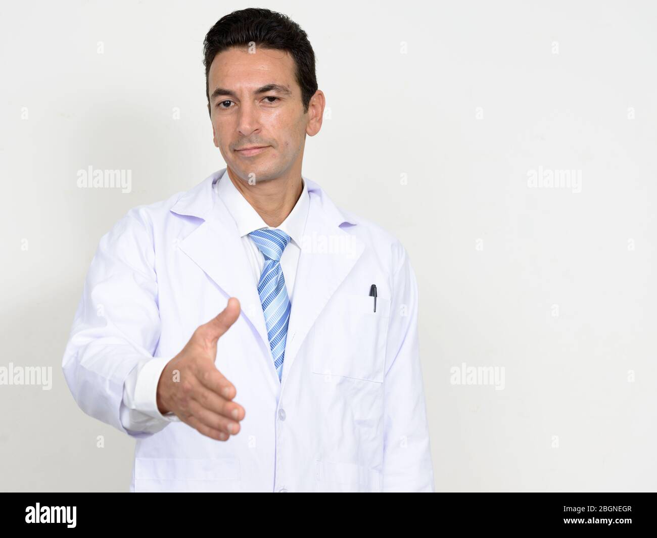 Portrait of mature handsome man doctor giving handshake Stock Photo - Alamy