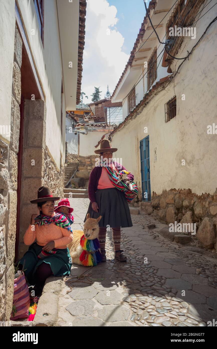 Family of locals in traditional clothing on the streets of old town ...