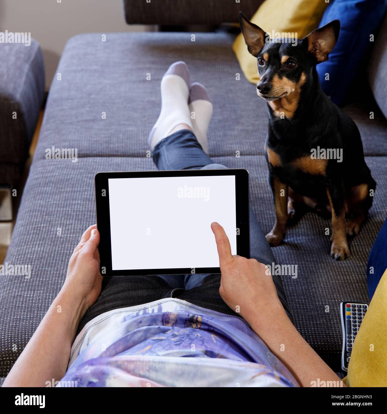 Young woman holding modern tablet with mock up blank white screen and ...