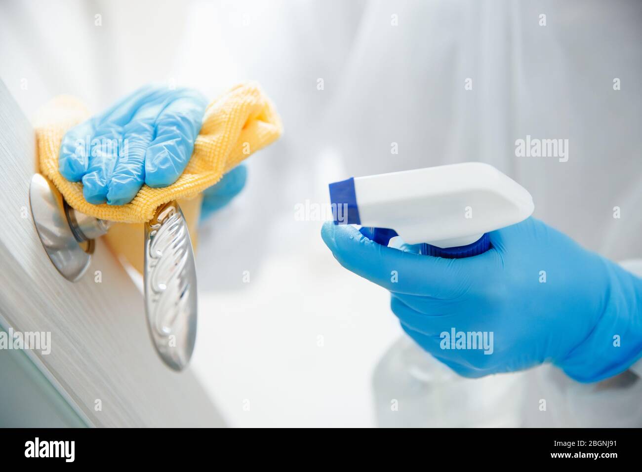 Disinfection and cleaning door handles of house from infection with ...