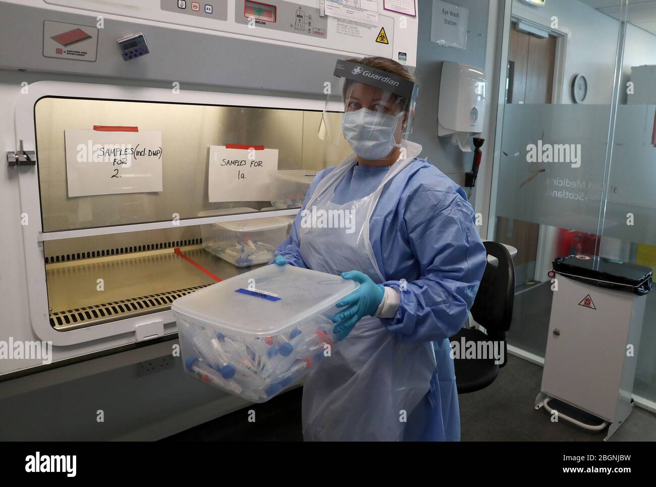 Live samples in test tubes are held in a container during the opening ...