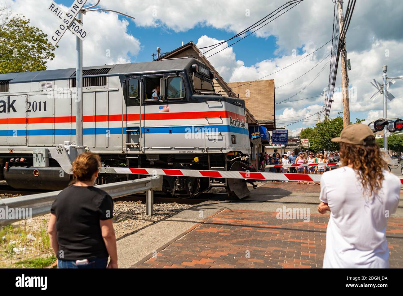 Beachgoers await a train to pass before hitting the sands at Old ...