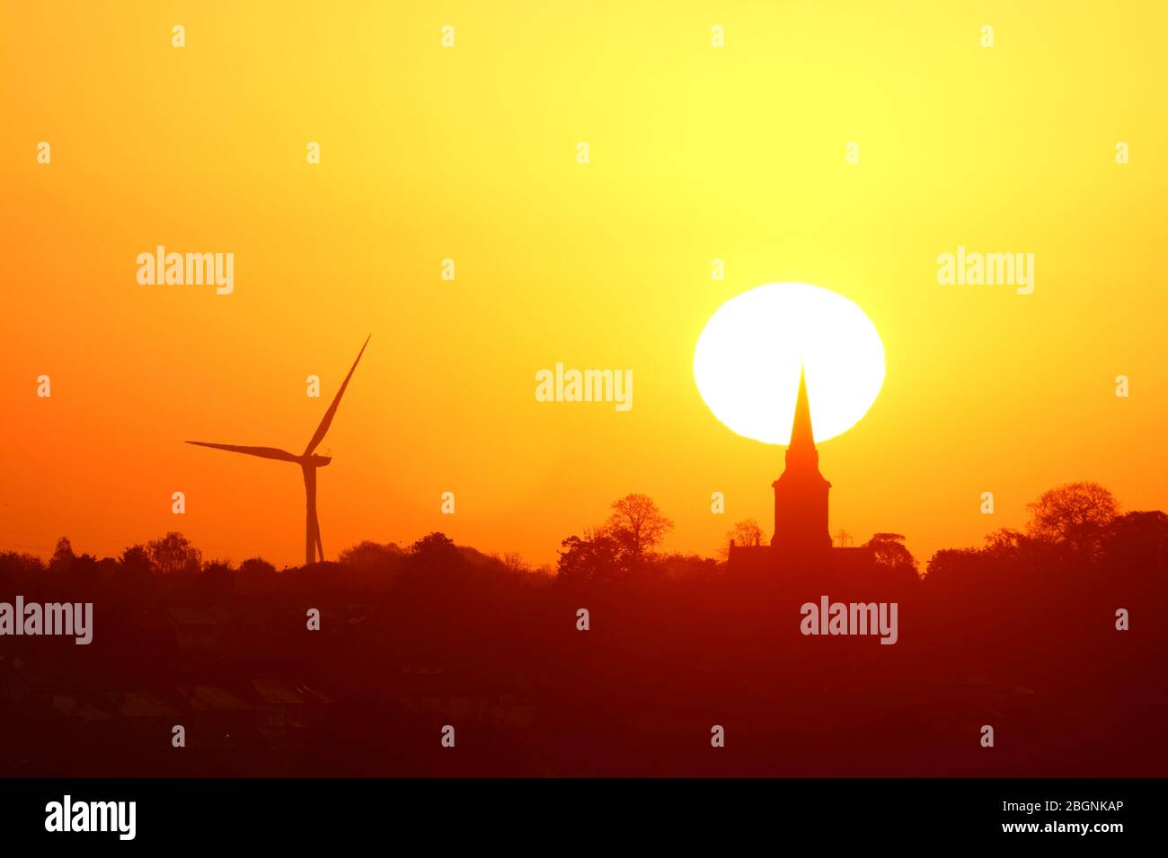 A golden sun rising behind St Mary's Church in Garforth & Hook Moor ...