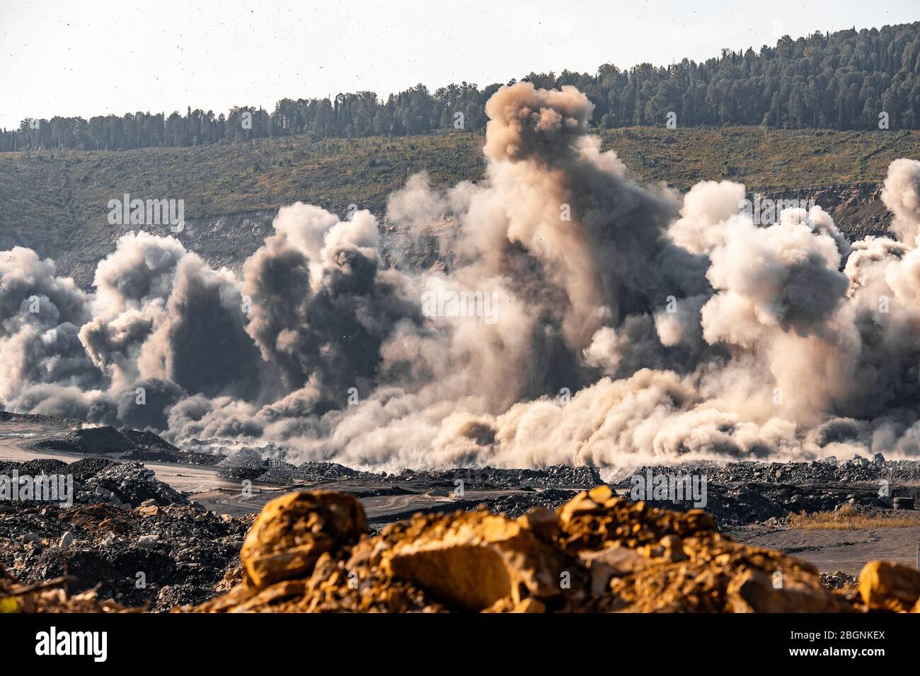 Explosive works on open pit coal mine industry with dust and puffs of ...
