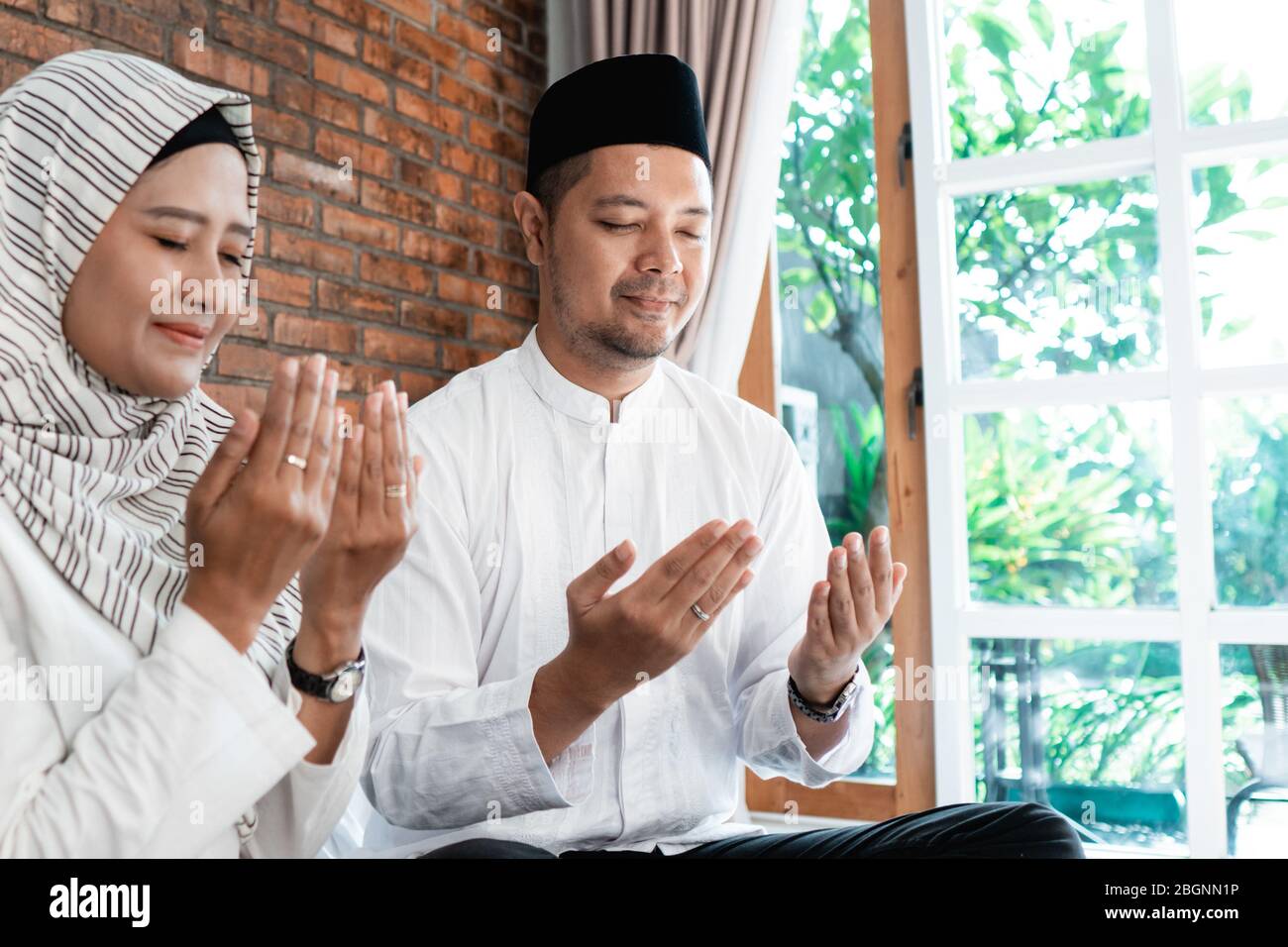 muslim woman and man pray open their arm and close eyes Stock Photo - Alamy