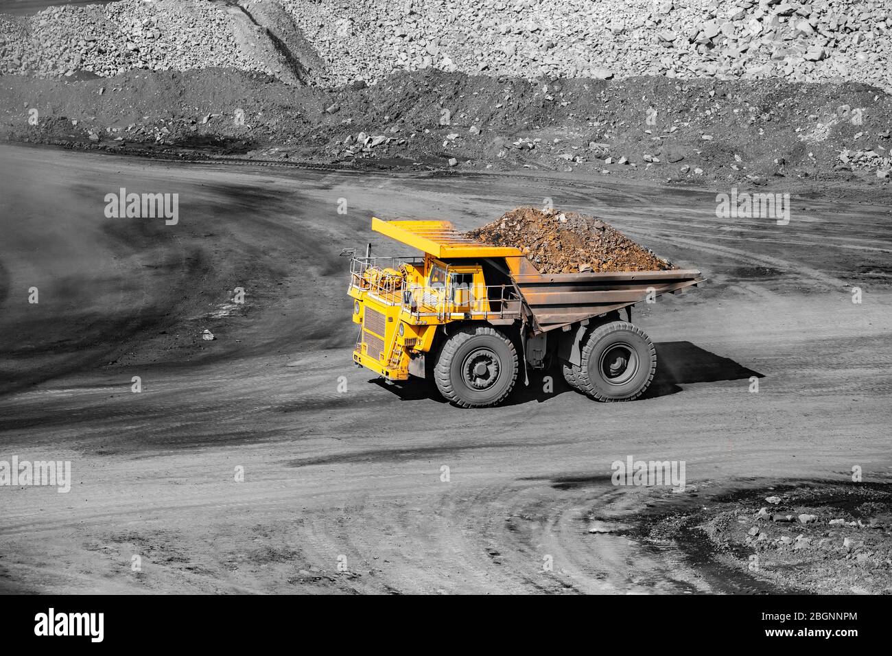 Big yellow mining truck transportation of gold ore. Open pit mine ...