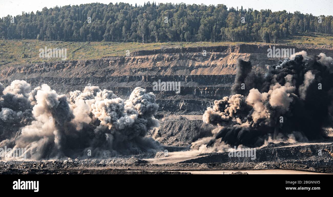Explosive works on open pit coal mine industry with dust and puffs of ...