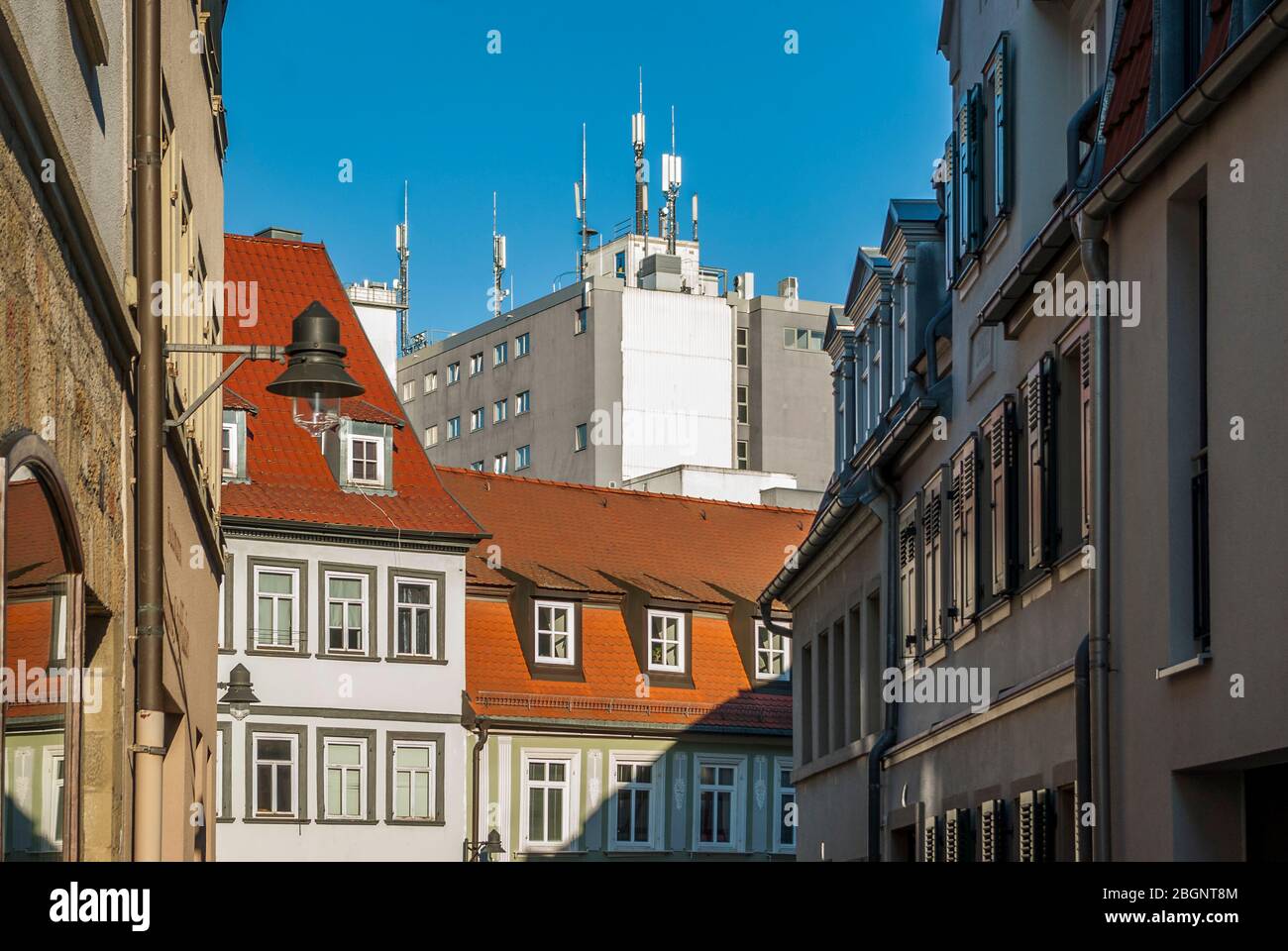 Old town alley with renovated houses background modern business ...