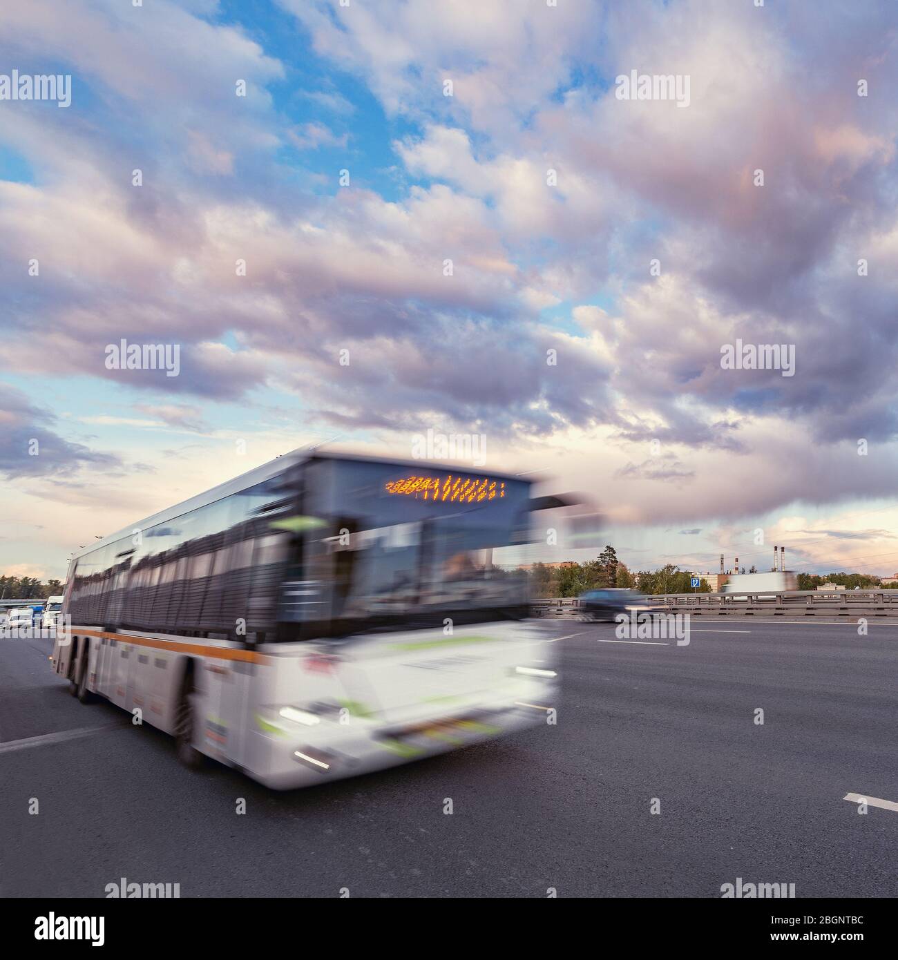 Passenger bus in motion on the highway at sunset Stock Photo - Alamy