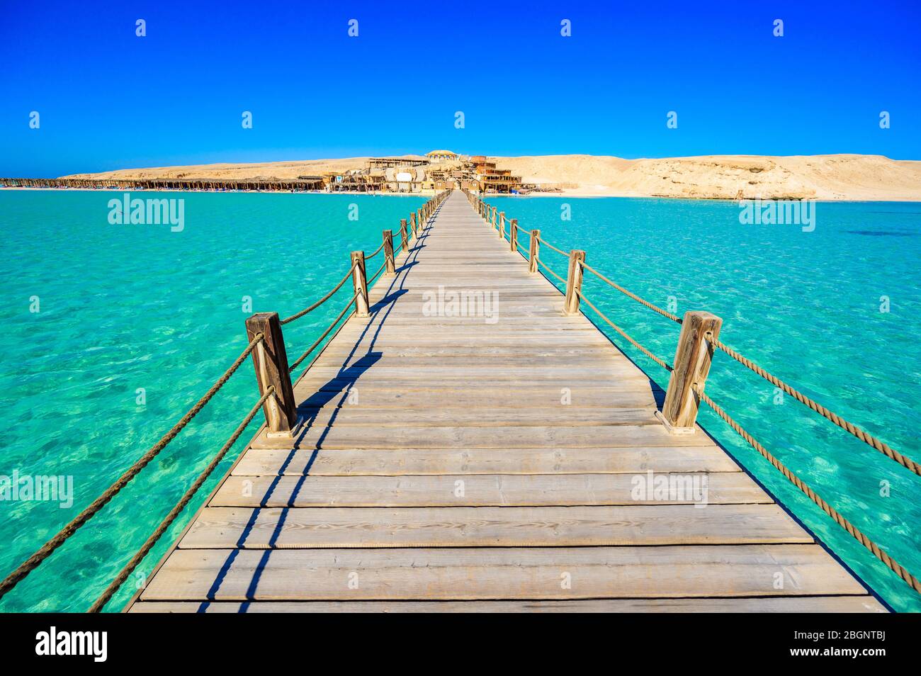 Wooden Pier at Orange Bay Beach with crystal clear azure water and ...