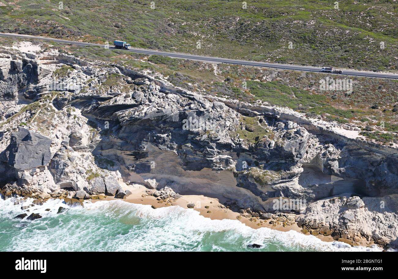 Aerial view of car driving along Baden Powell Drive and ocean cliffs ...