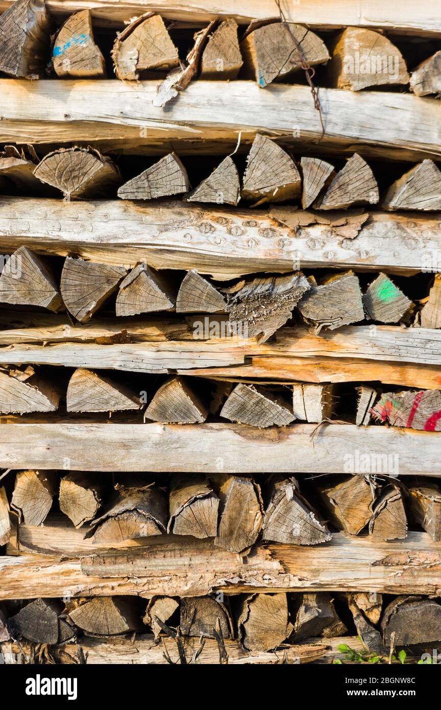 Wood stack of neatly piled firewood in the stack of crates for drying ...