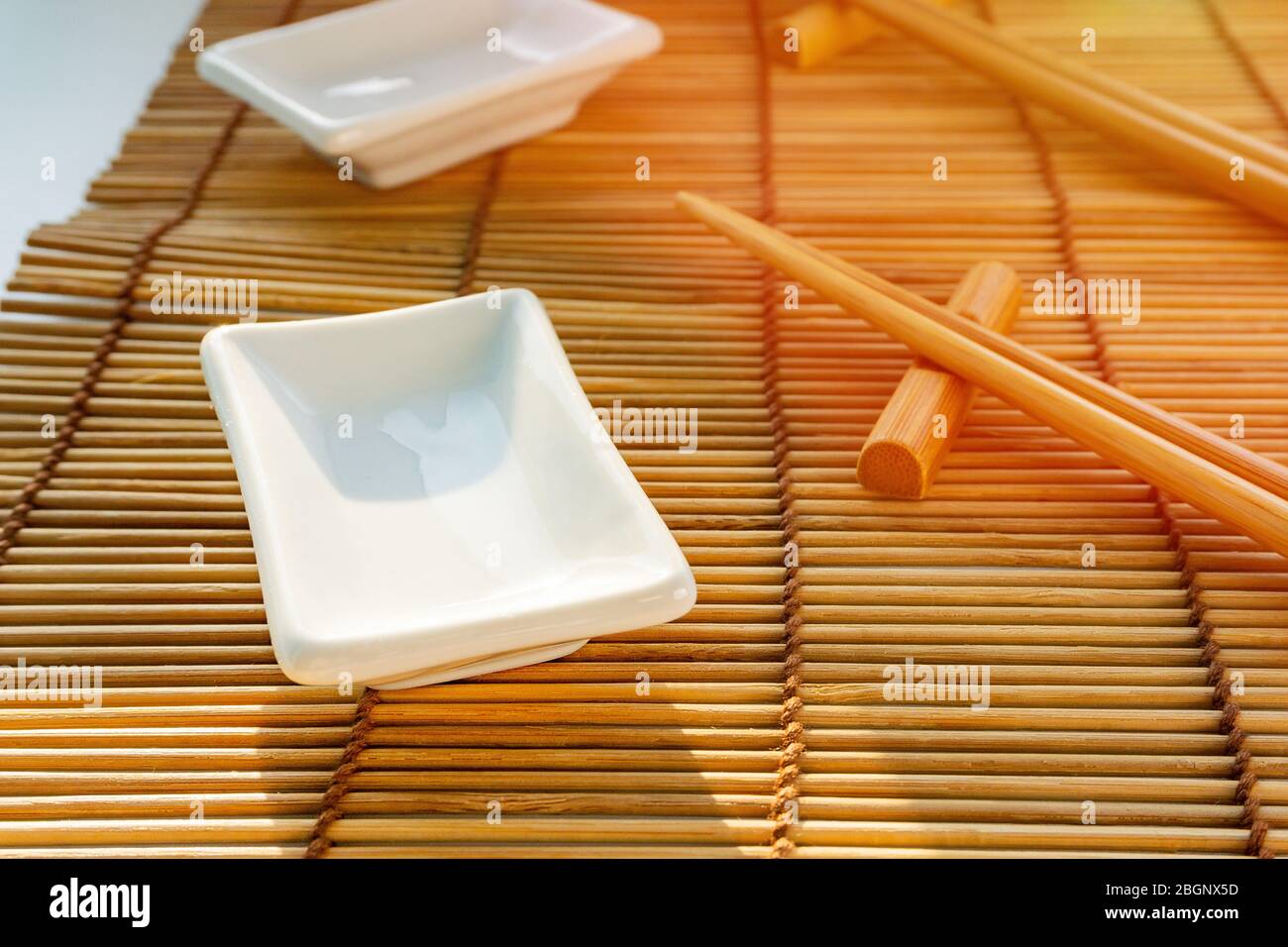 empty white plates, bamboo sticks, a roll set, sushi. traditional ...