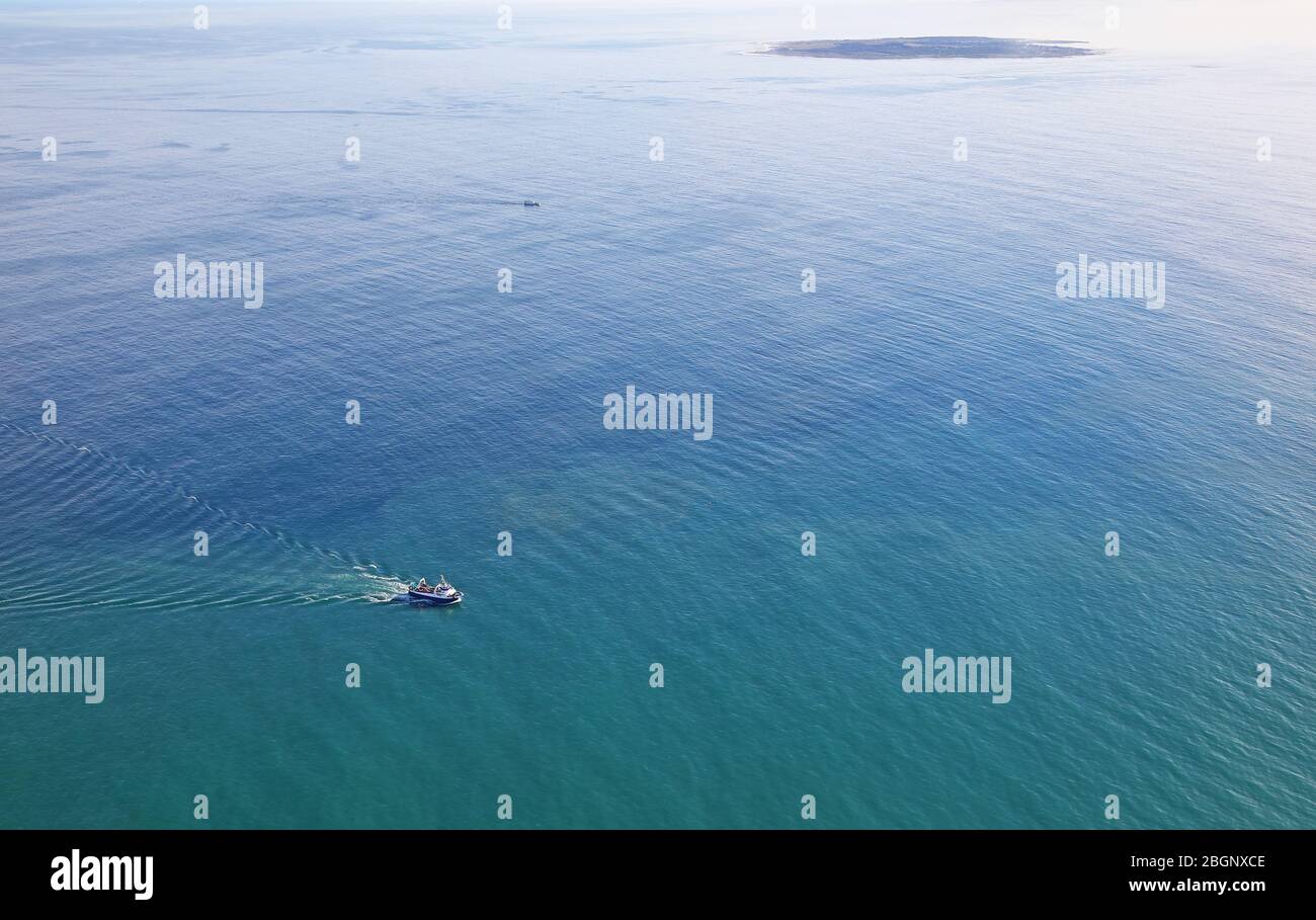 Aerial view of vessel in Table Bay with Robben Island in the background ...