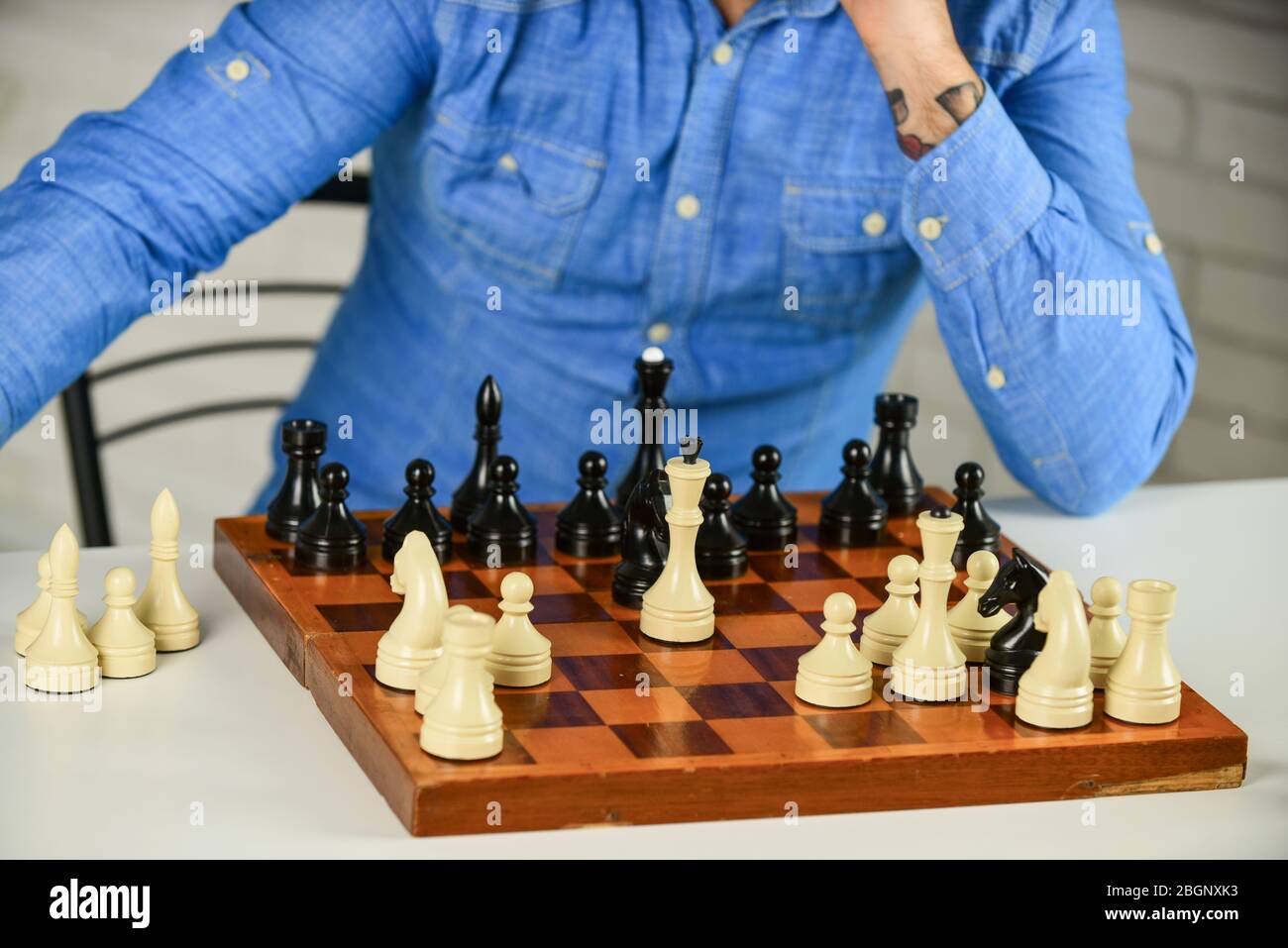 Intellectual hobby. Figures on wooden chess board. Thinking about next ...