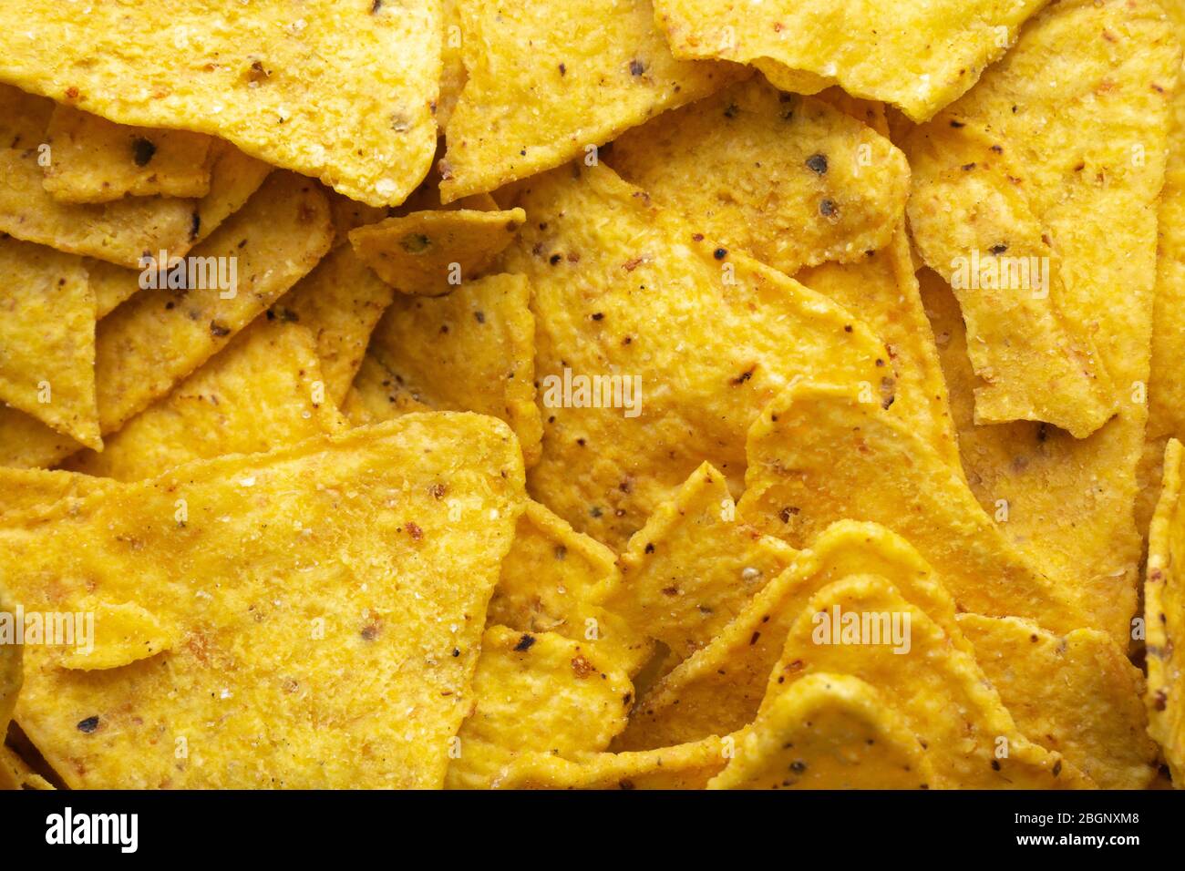 Nachos corn chips with spicy sauce close-up. Abstract food textures ...