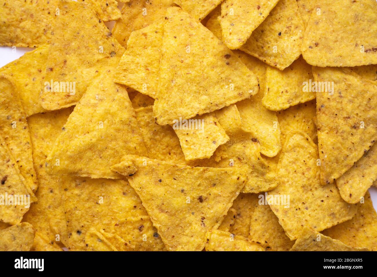Nachos corn chips with spicy sauce close-up. Abstract food textures ...