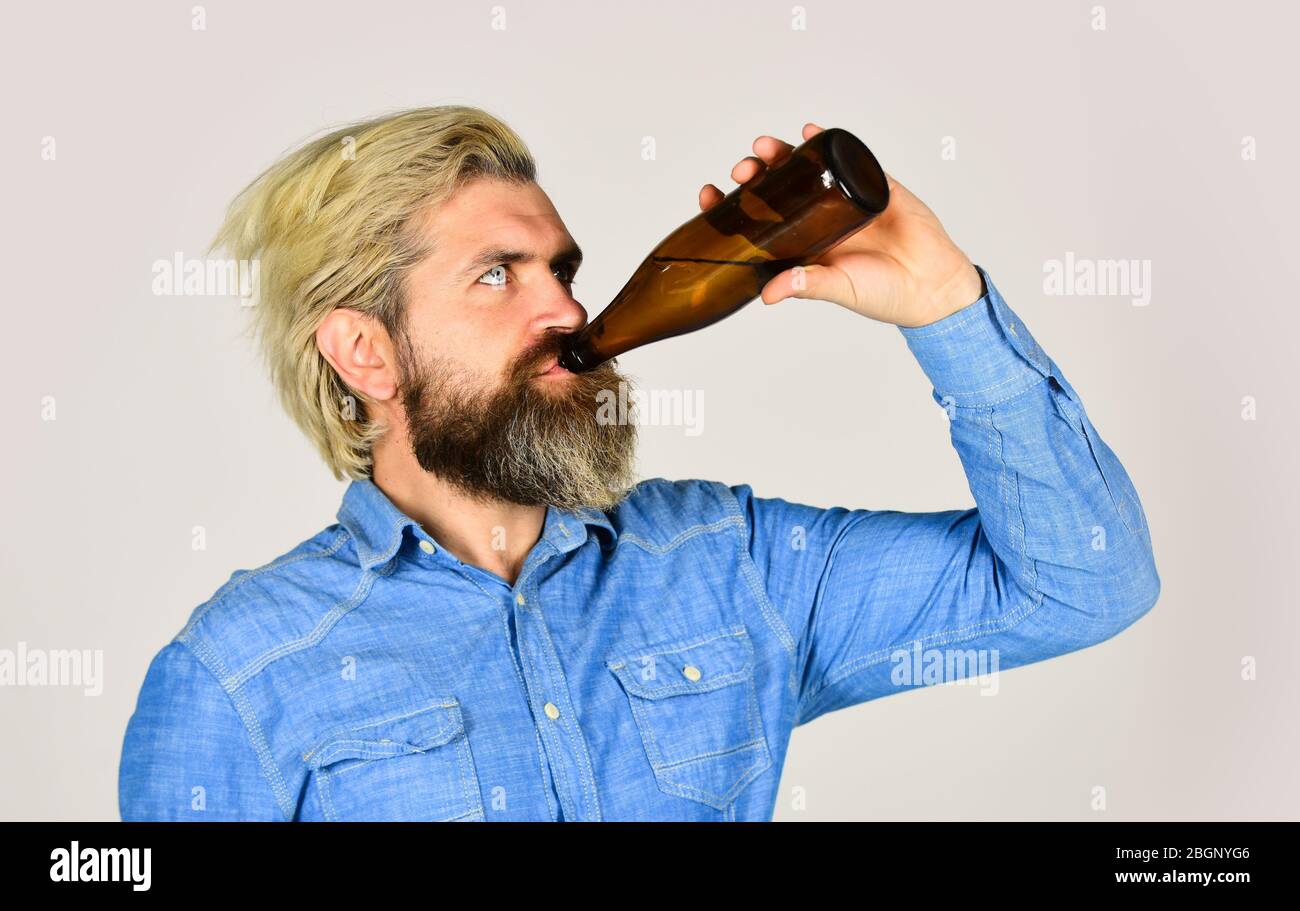 Beer is Full of a new Skill. stylish handsome man drinking from beer bottle. clear pour water ...