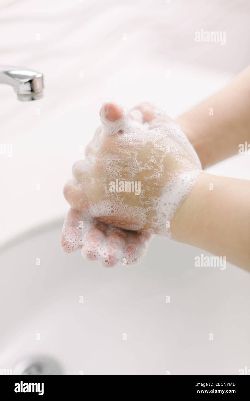 Woman washes her hands by surgical hand washing method. She washes his ...
