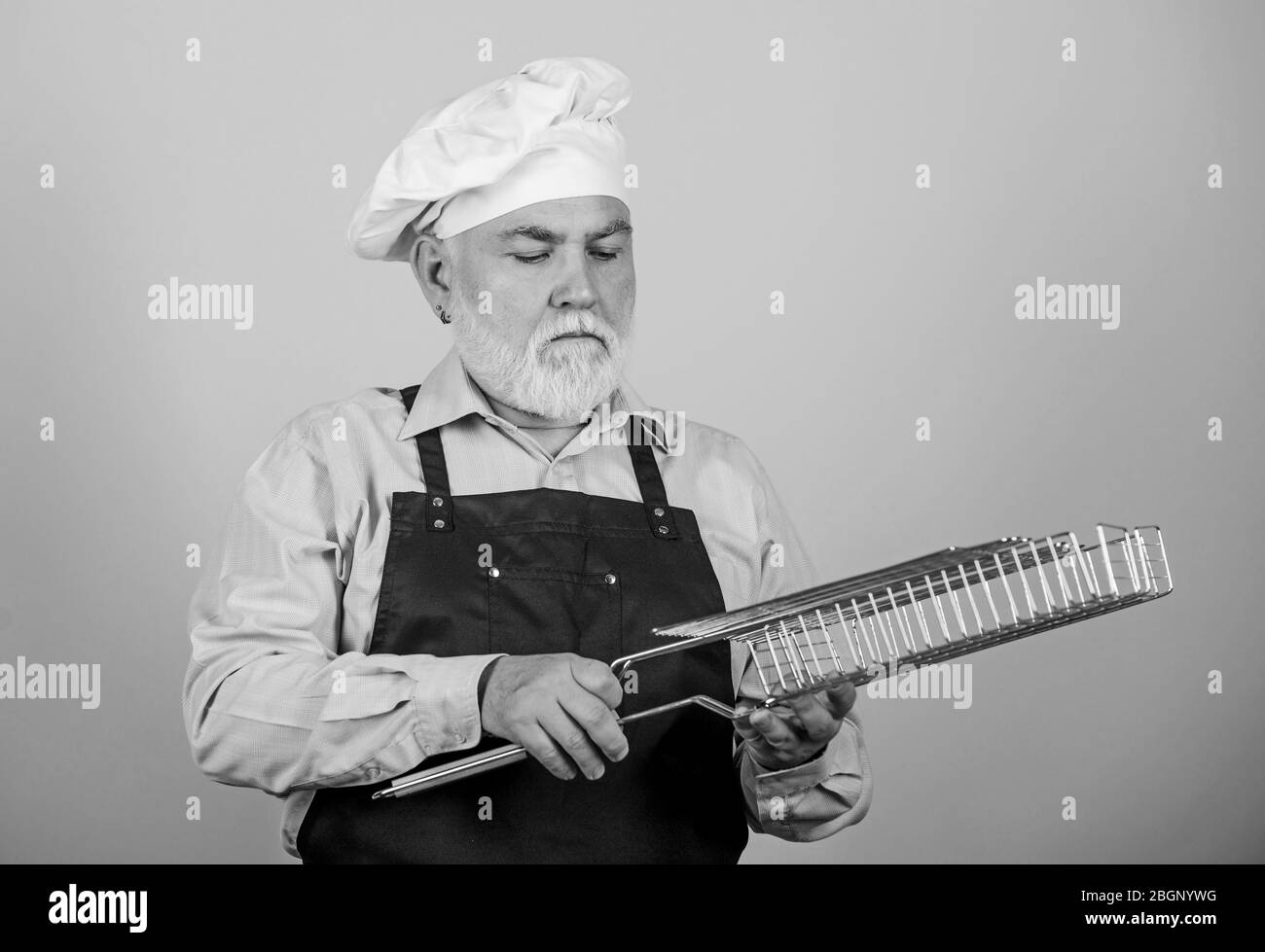 Cooking healthy. cook men with beard. cooking utensils for barbecue. he ...