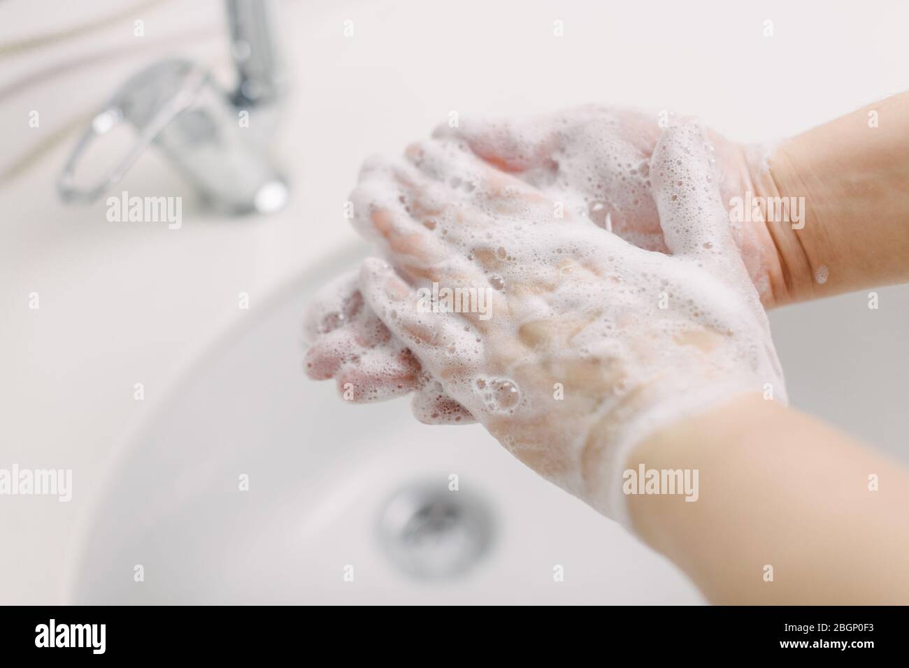 Woman washes her hands by surgical hand washing method. She washes his ...