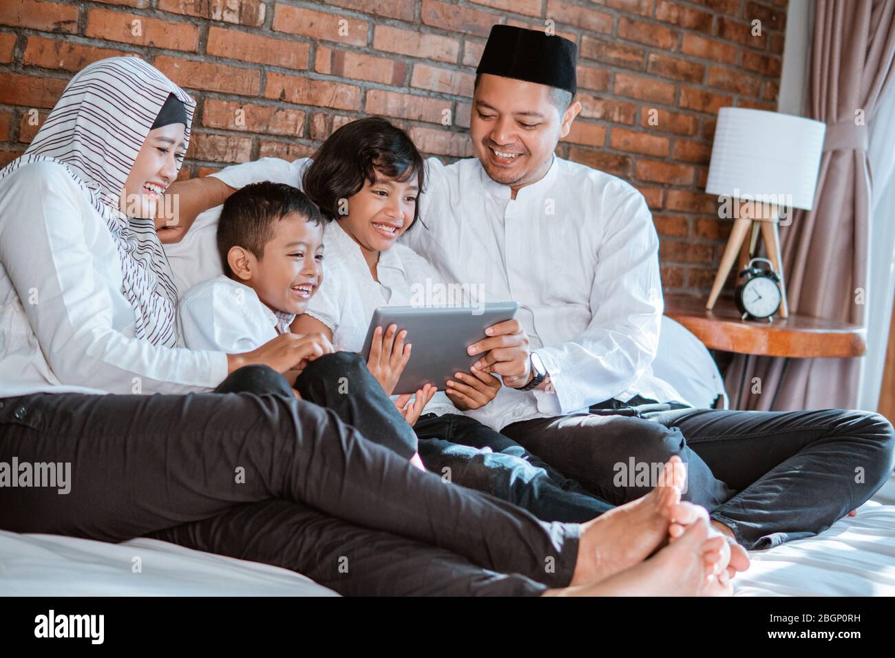 muslim family using tablet together during eid mubarak stay home Stock ...