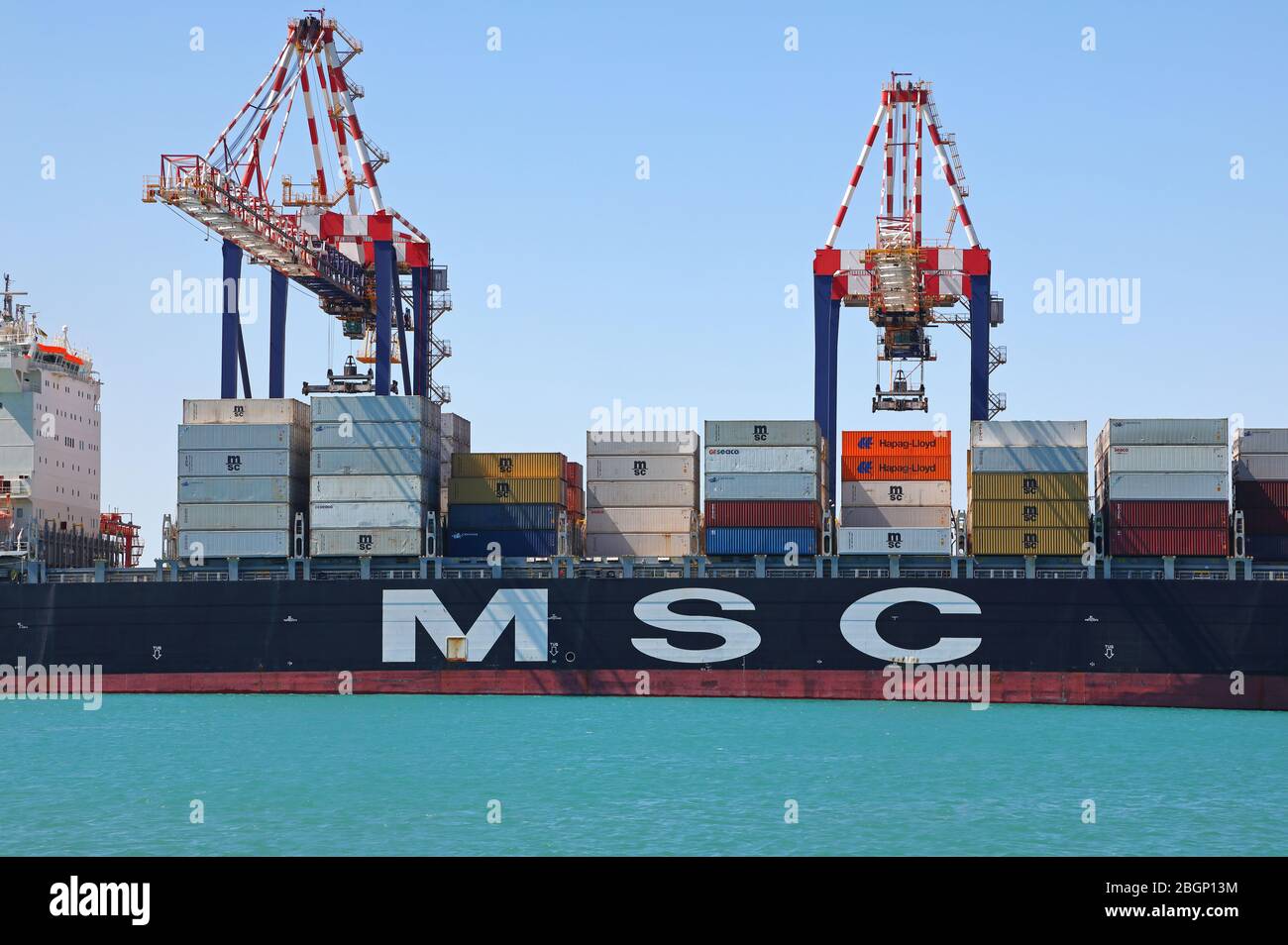 Container ship being positioned by a tug Stock Photo - Alamy
