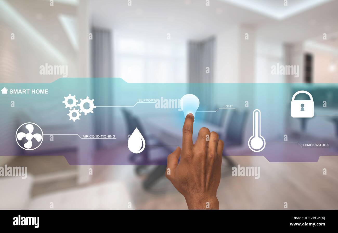 Internet of things. Millennial guy using remote smart home control ...