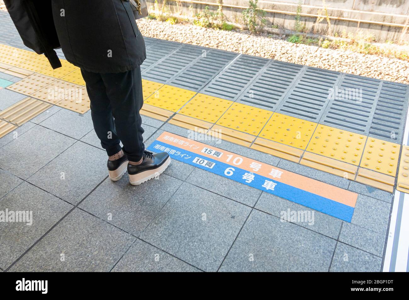 Platform floor at Tokyo subway station has the bogie numbers to show ...