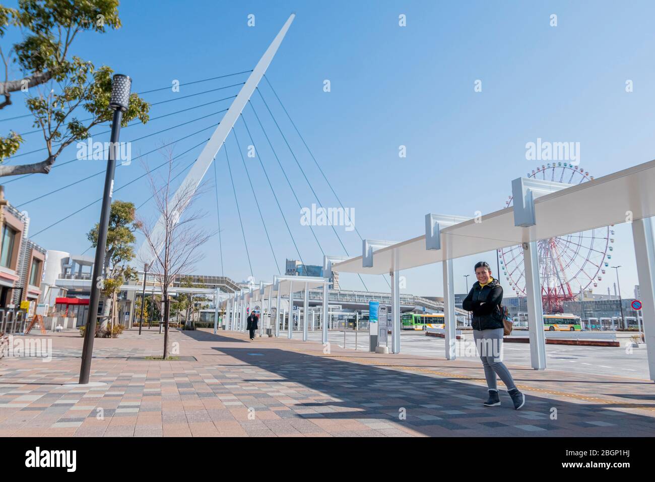 An Asain woman is take a photo at Daiba bus station with ferris wheel ...