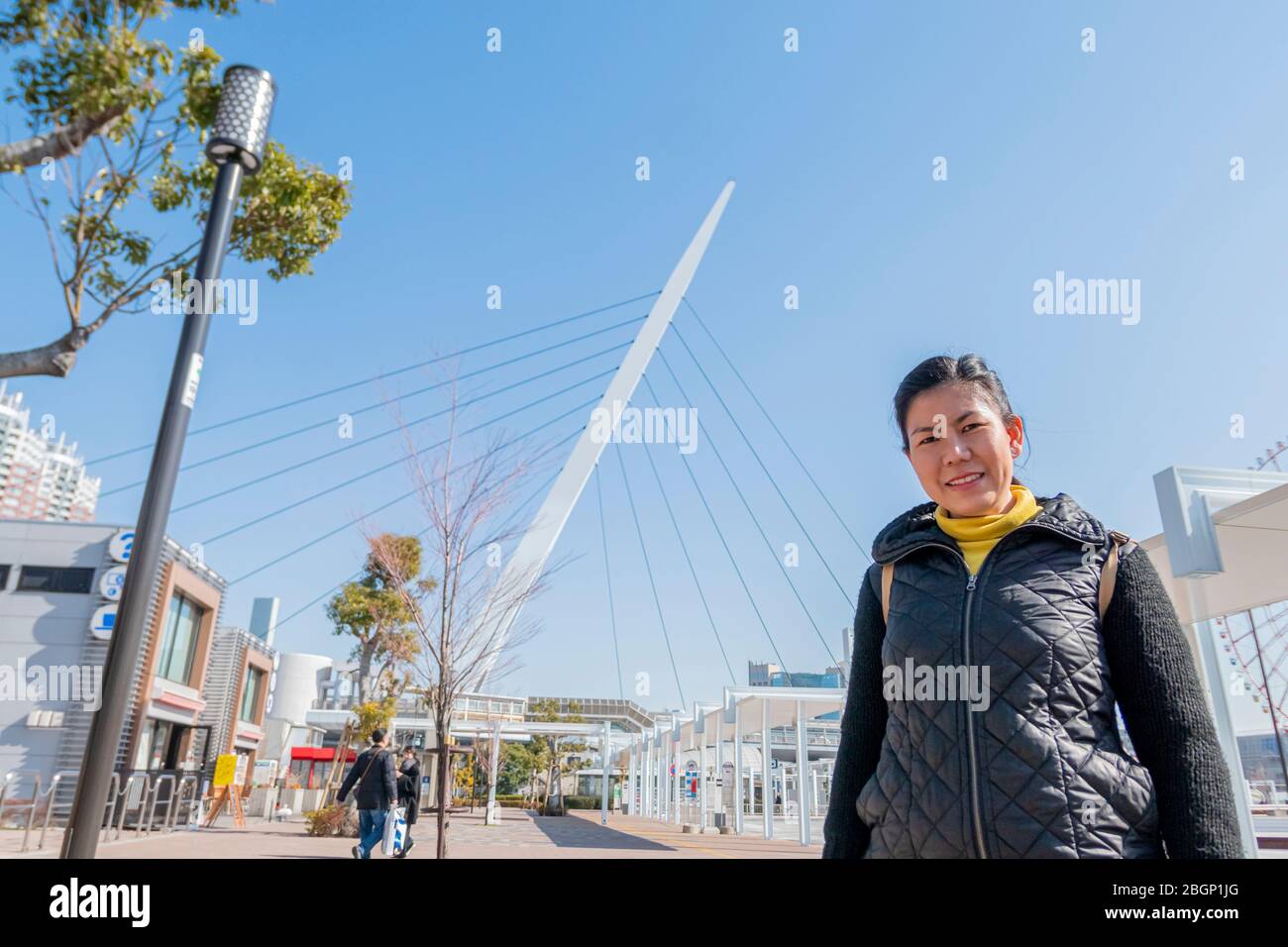 An Asain woman is take a photo at Daiba bus station with ferris wheel ...