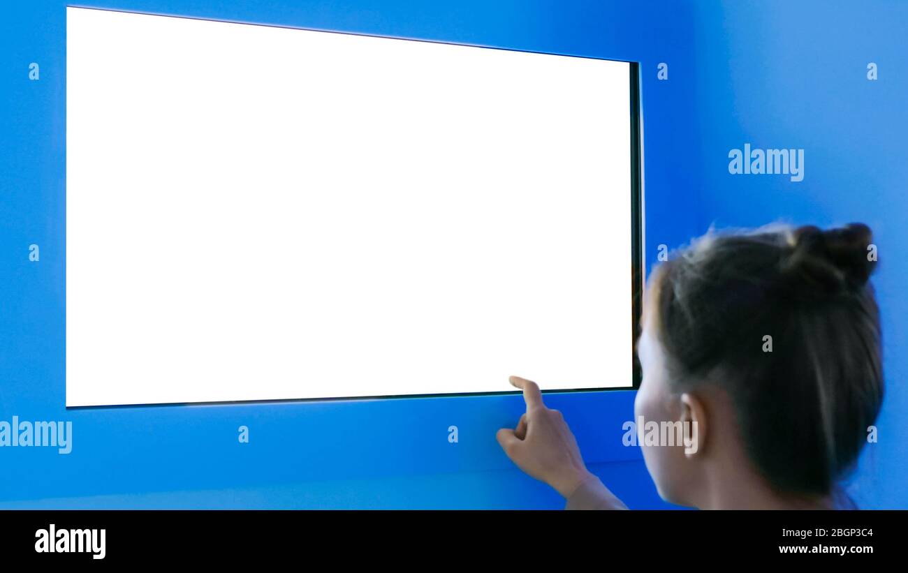 Woman using white empty interactive touchscreen display at modern ...
