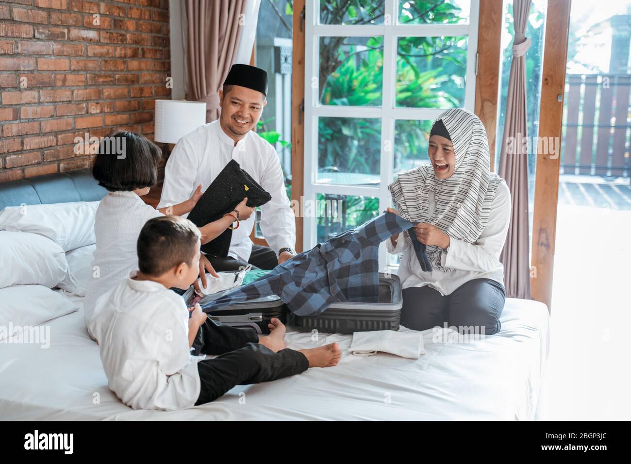 Muslim family prepare clothes and suitcase for carried when mudik go to ...