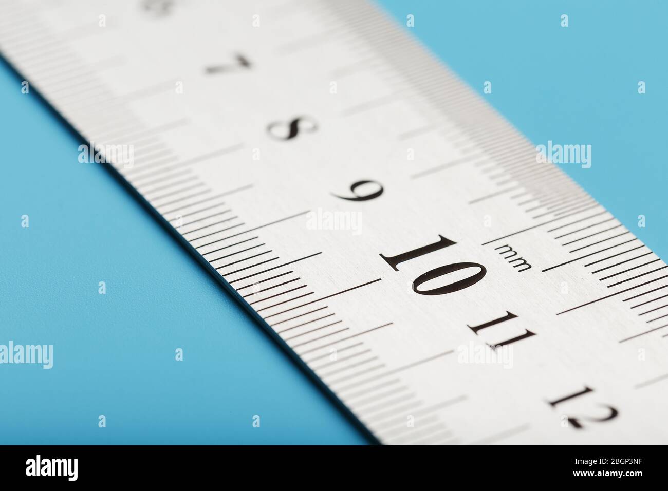 Metal ruler on a blue background close-up with a copy of the spa Stock ...
