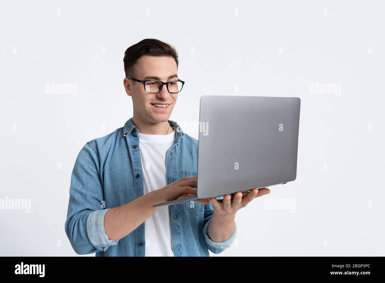 Young guy with laptop hi-res stock photography and images - Alamy