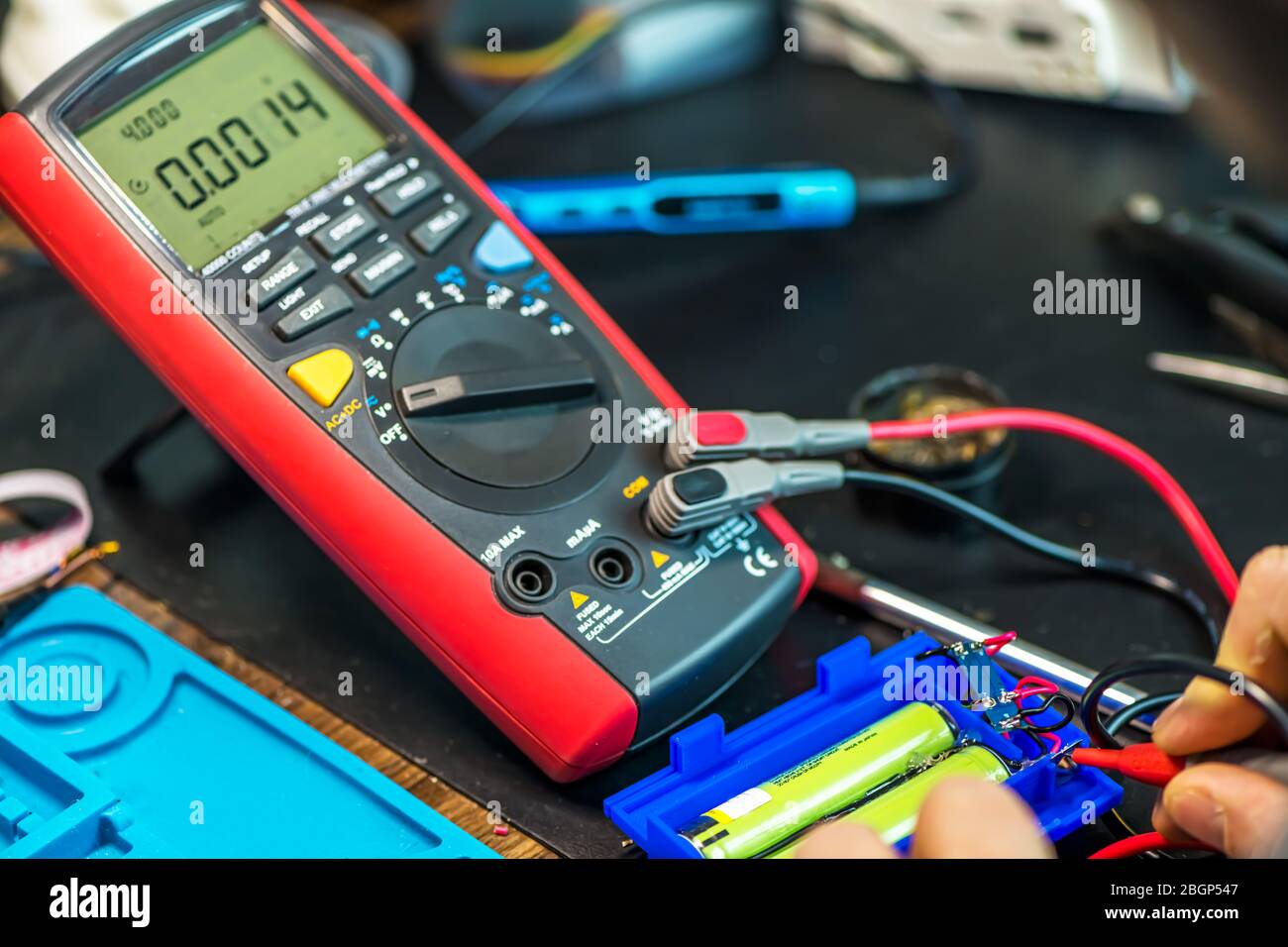technical master tests the battery voltage. battery, wires. technical ...