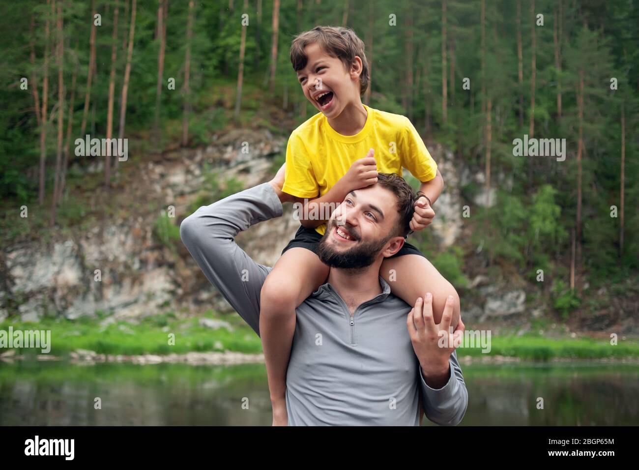 Father and son are smiling while spending time together. Little boy ...