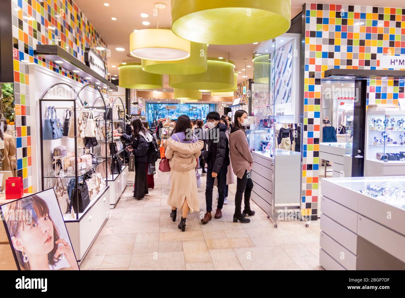 Japanese woman is choosing some clothing and leather bags to buy at the ...