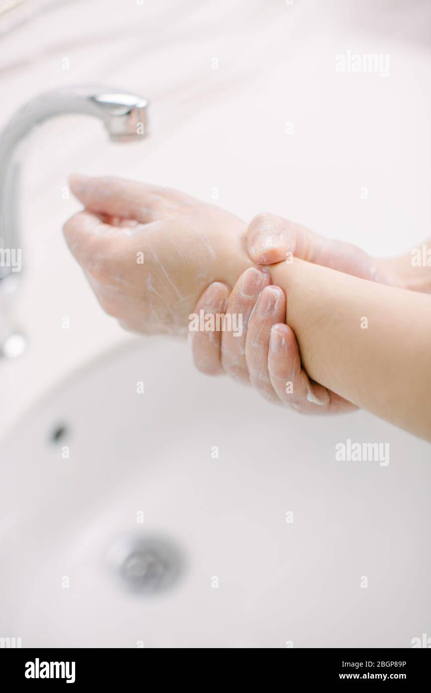 Woman washes her hands by surgical hand washing method. She washes his ...