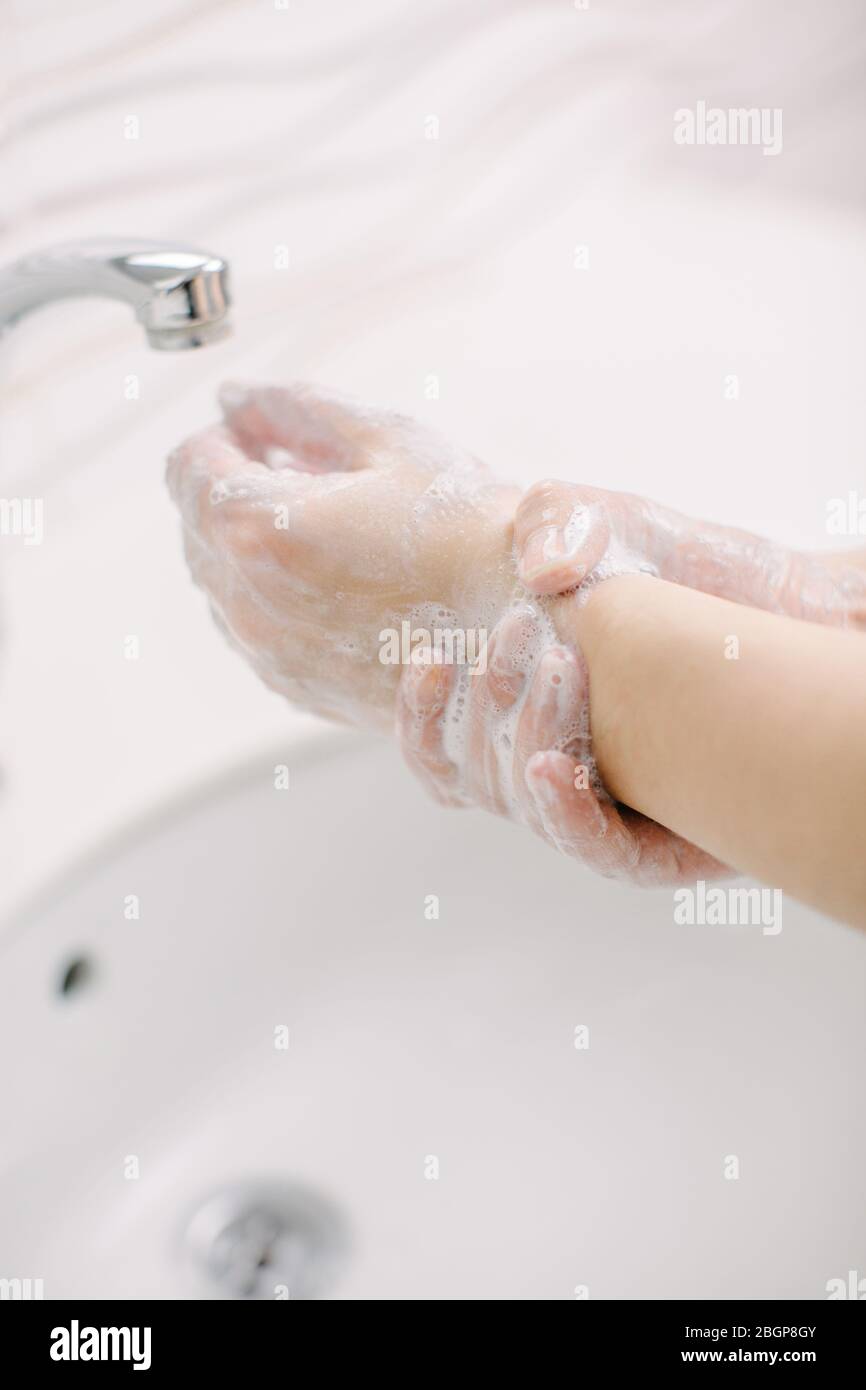 Woman washes her hands by surgical hand washing method. She washes his ...