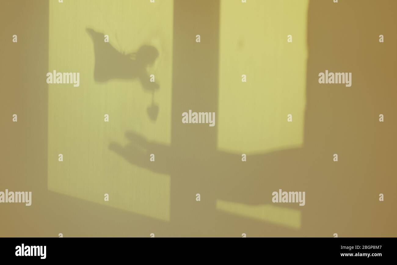 A window frame featuring an angel's silhouette and a woman's hand Stock ...